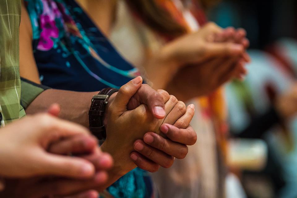 Holding hands in prayer – Santuario de San Antonio Parish